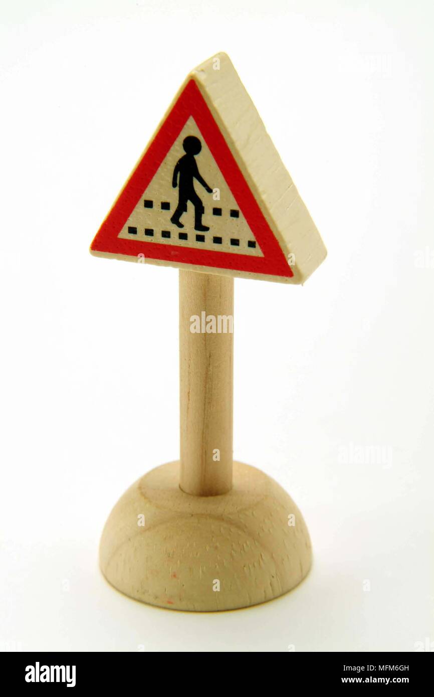 A side view of a simple wooden toy road sign warnig traffic of a ...