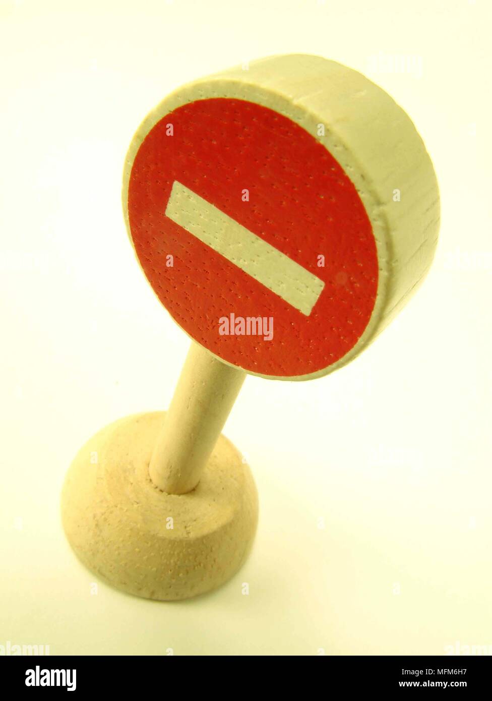 A high dramatic side view of a simple wooden toy road sign showing No ...