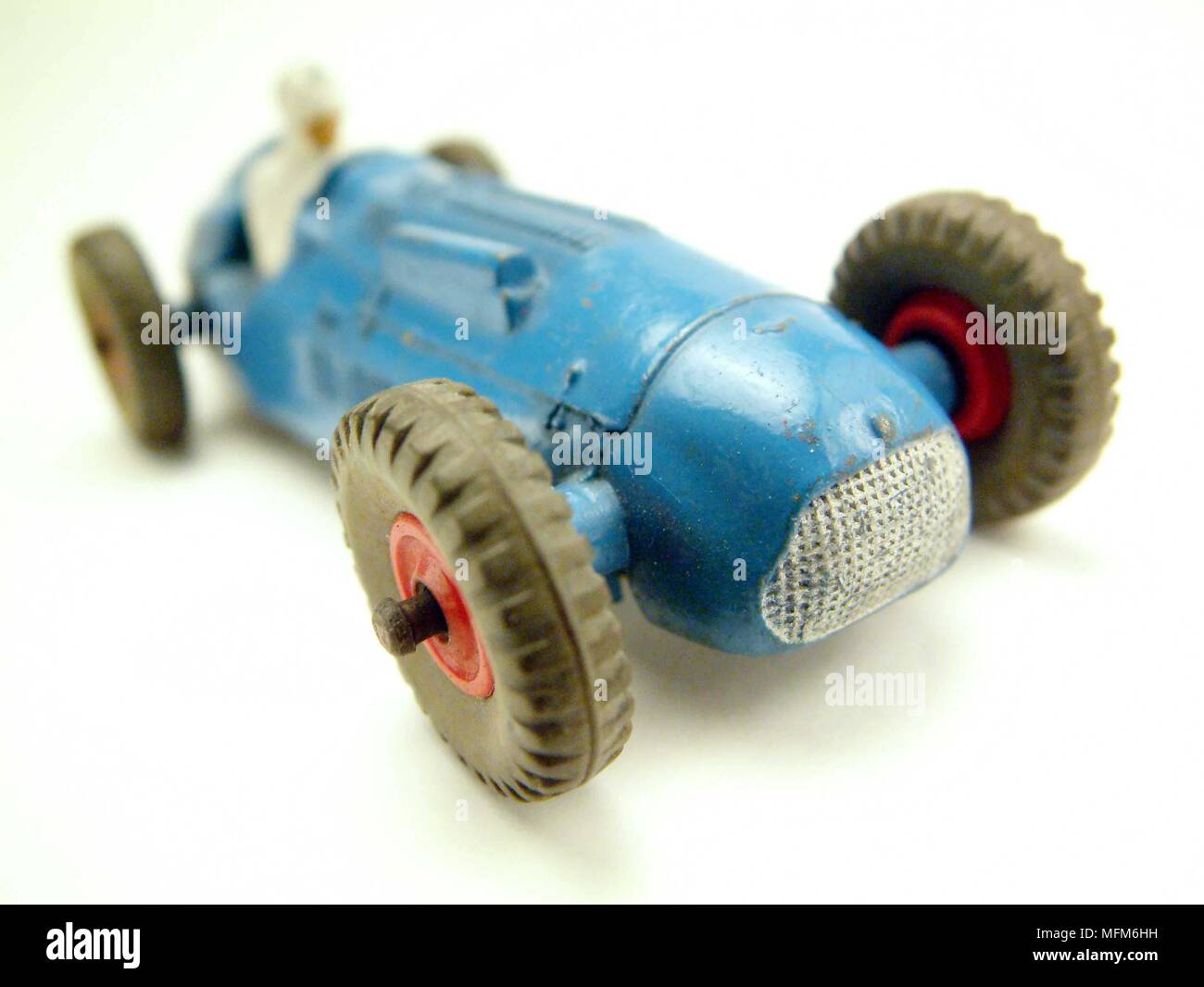 A dramatic view of a 1960's blue model die cast toy racing car ...