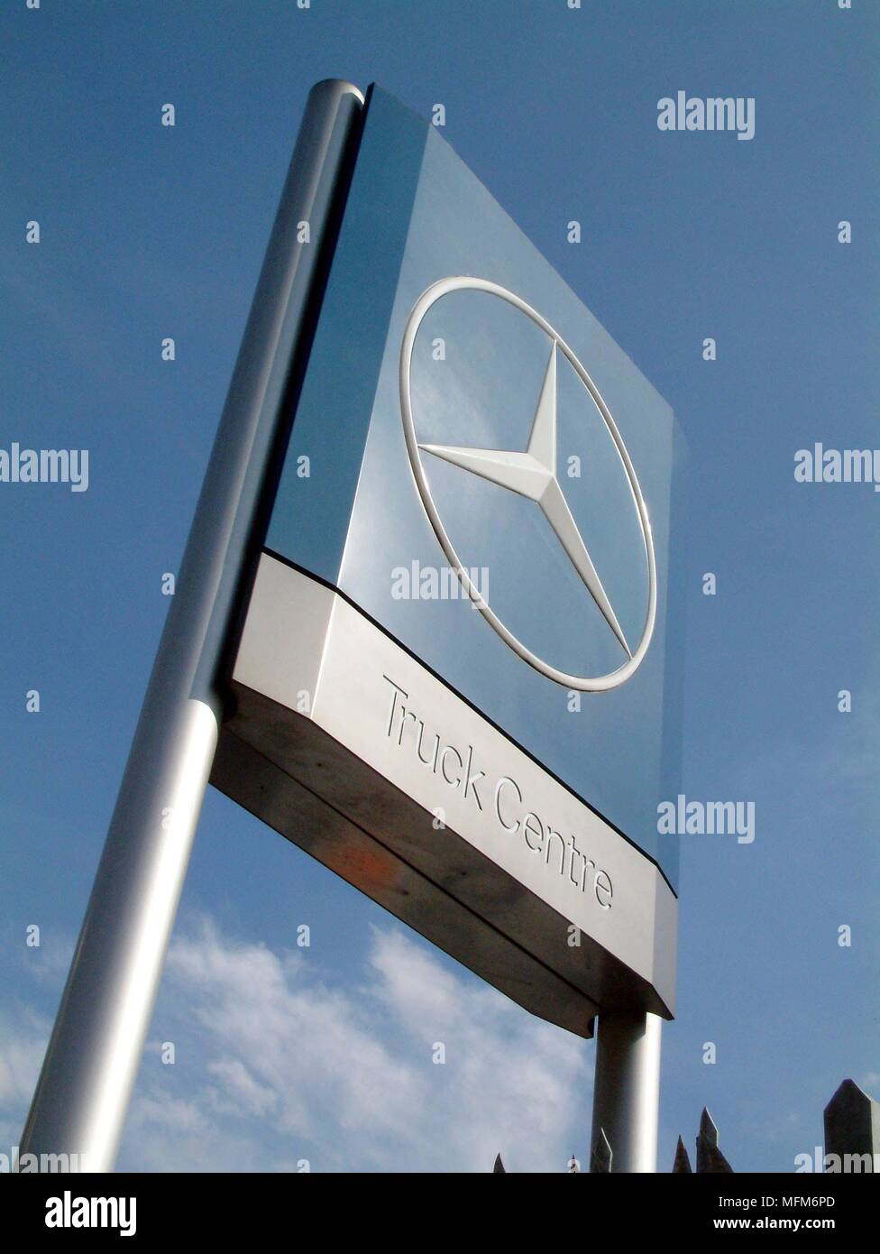 A large blue road side Mercedes Benz logo dealership sign shot against ...
