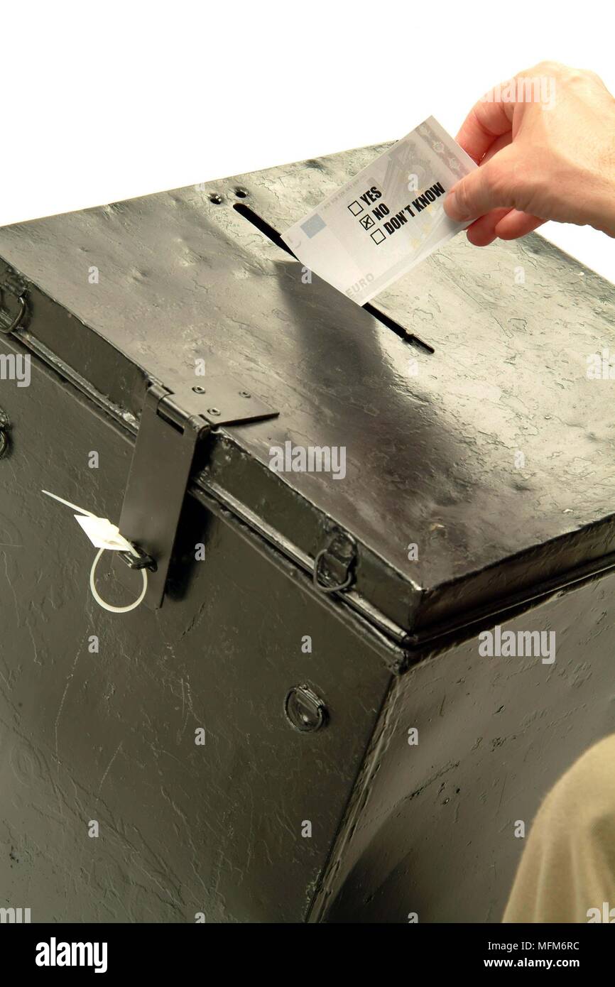 Close-up view on a black old fashioned metal ballot box with a hand ...