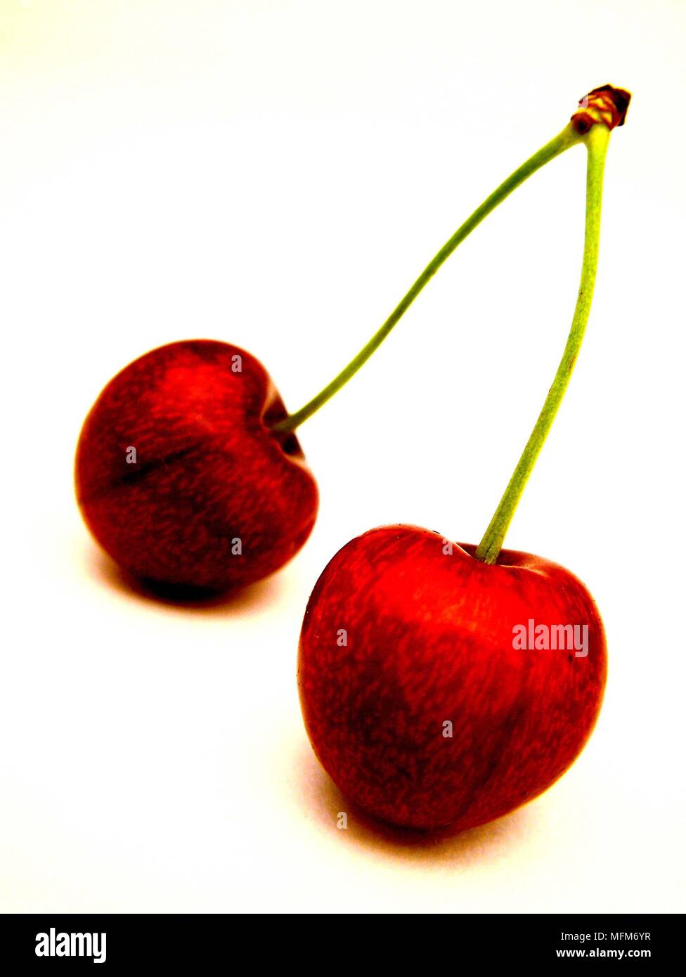 Studio cut-out still life photographs of a pairof cherries with the ...