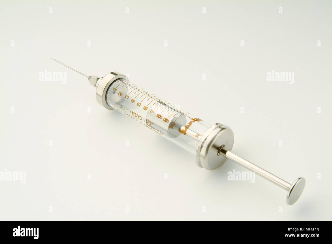 A large hypodermic syringe made from glass and stainless steel, made to ...
