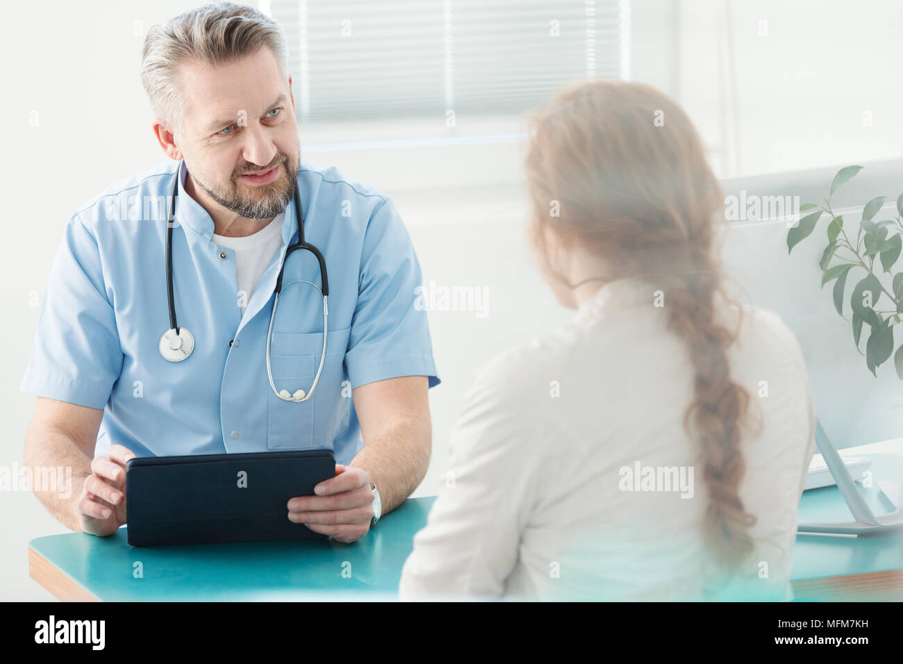 General doctor in blue uniform with stethoscope during medical ...