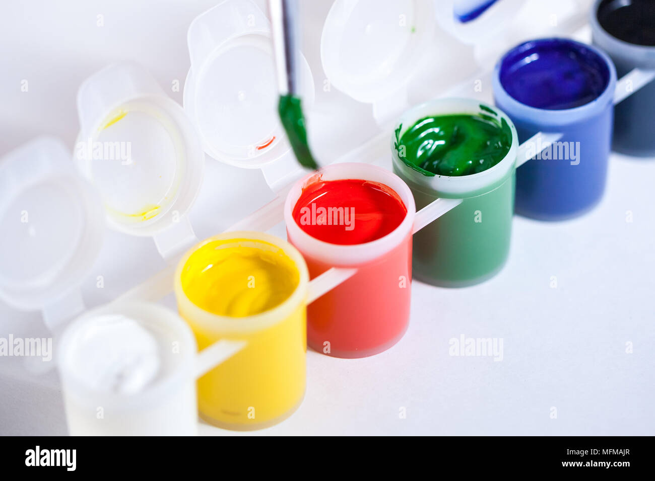 opened containers with paint of different colors Stock Photo - Alamy