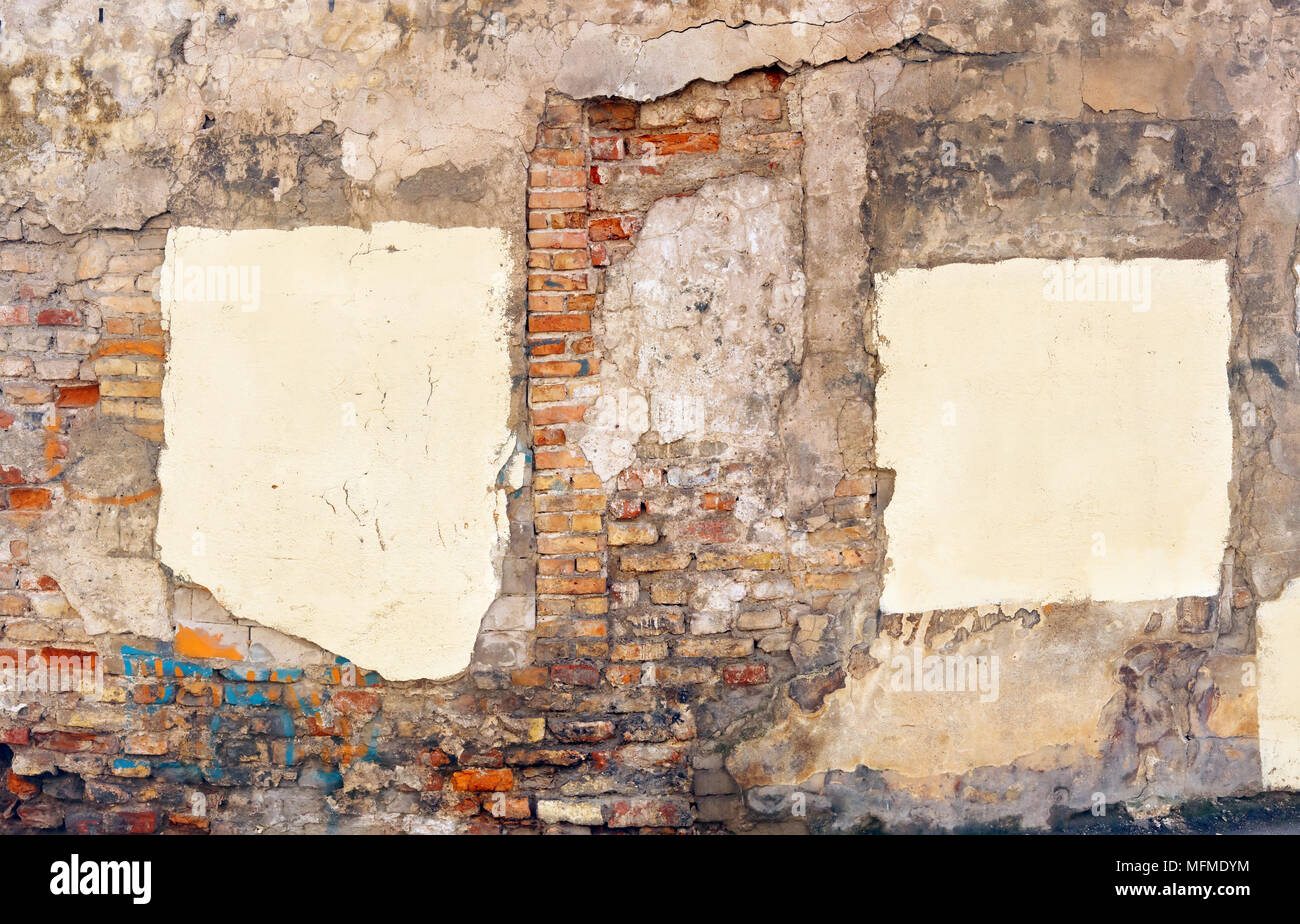 A piece of the wall of the ruined house with paint stains and yellow ...