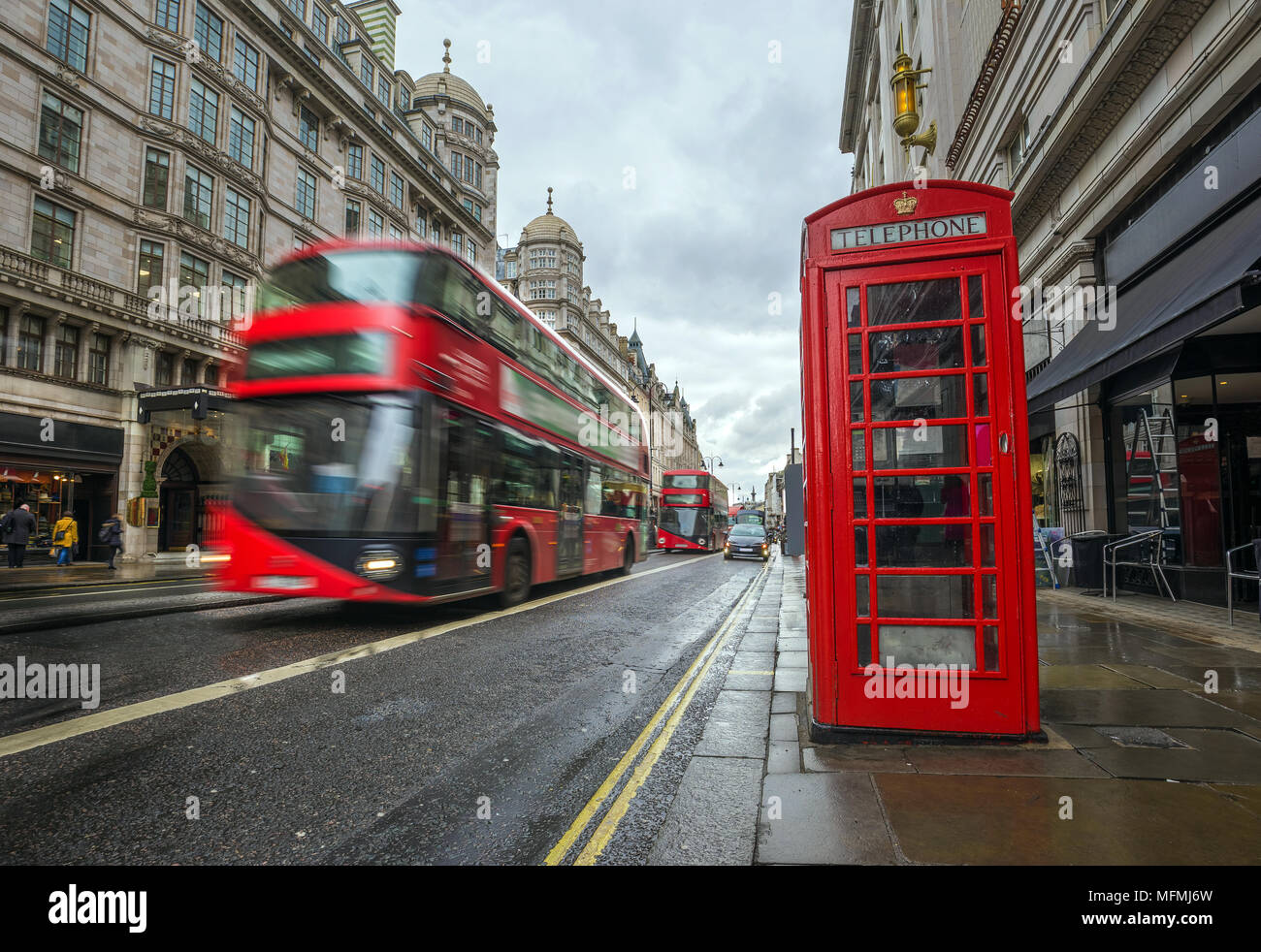 London, England - Iconic blurred red double-decker buses on the move ...