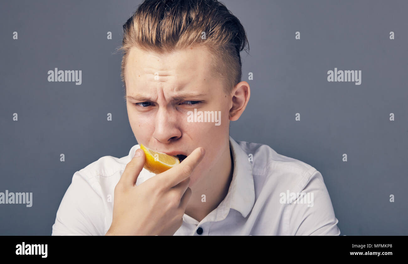 Boy grimace face taste fruit hi-res stock photography and images - Alamy