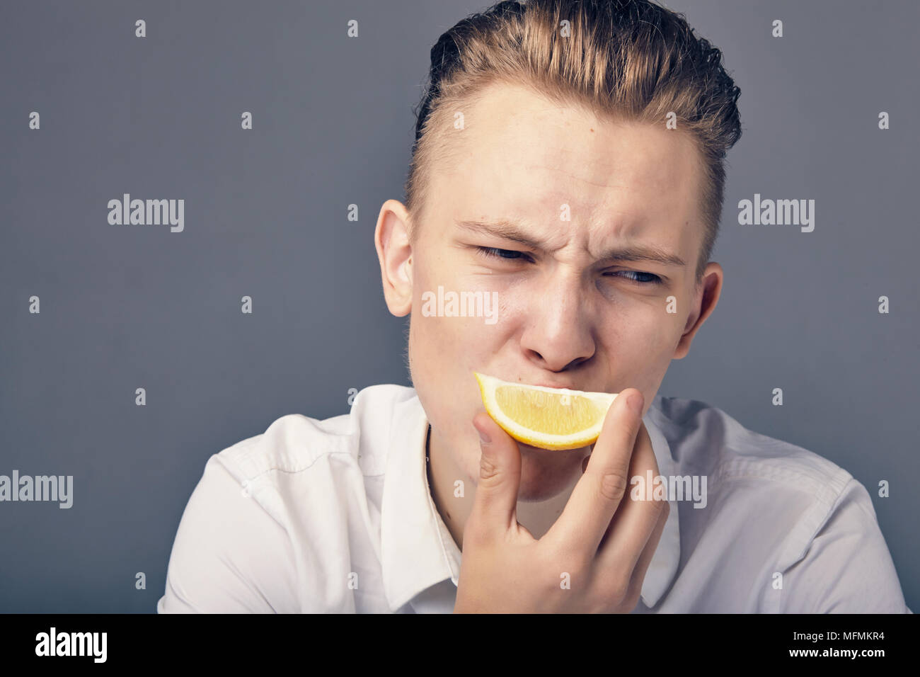 Boy grimace face taste fruit hi-res stock photography and images - Alamy