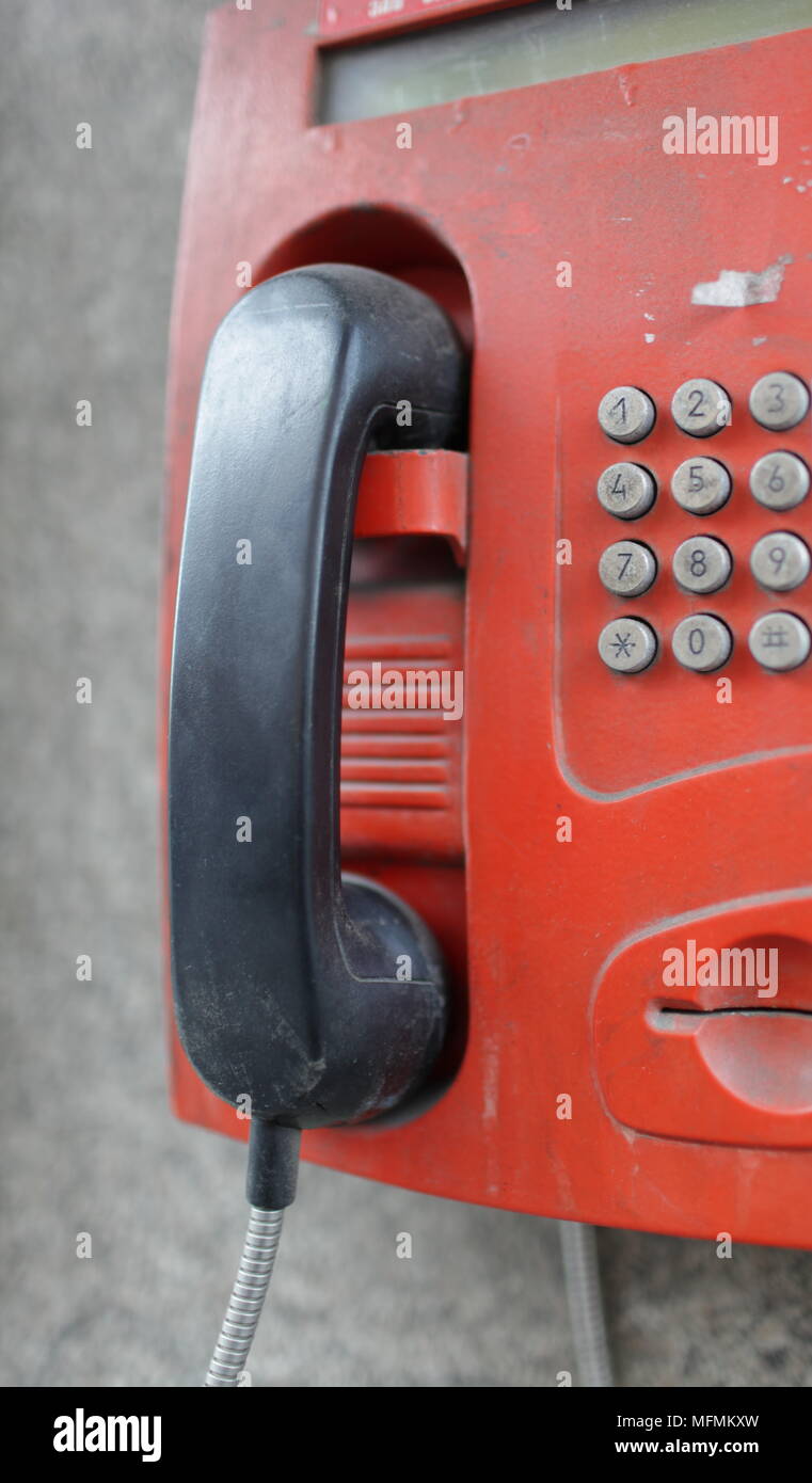 Red public payphone on the wall Stock Photo - Alamy