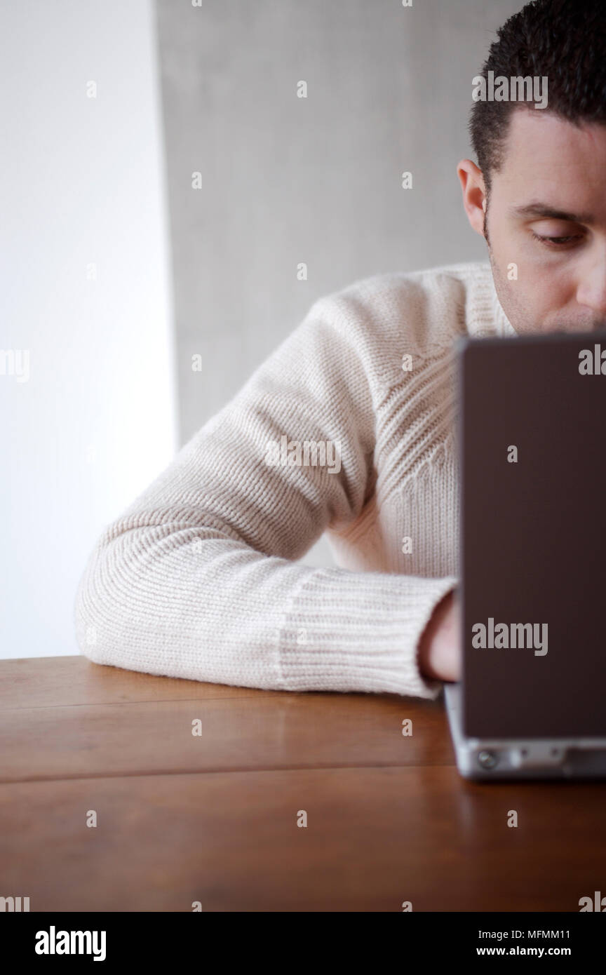 Close-up of a young man using a laptop Ref: CRB412 10004 059 Compulsory ...
