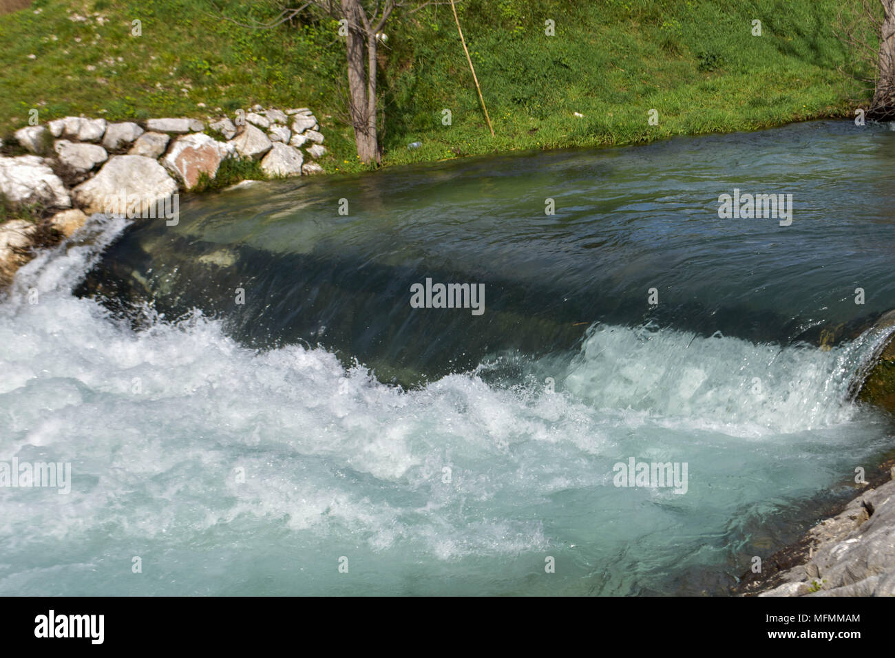 A close up photograph of a small waterfall made from stone wall, Small ...