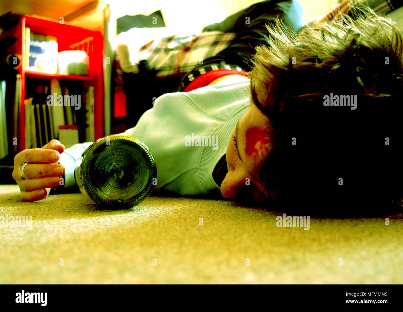 Close-up of a dead body lying on the floor with bloody bruise on the ...