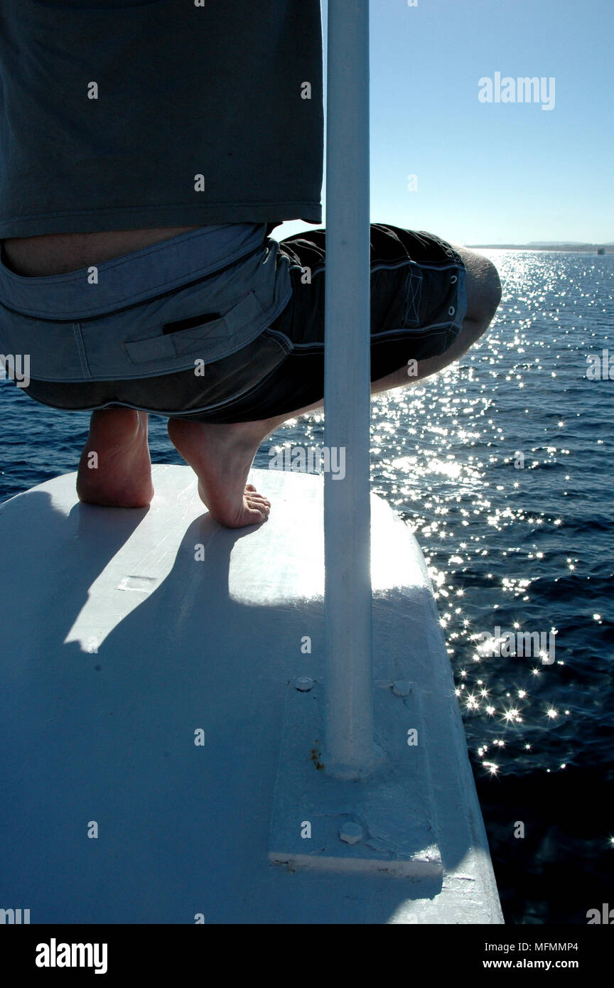 Rear view of a man crouching in a boat Ref: CRB416 10009 056 Compulsory ...