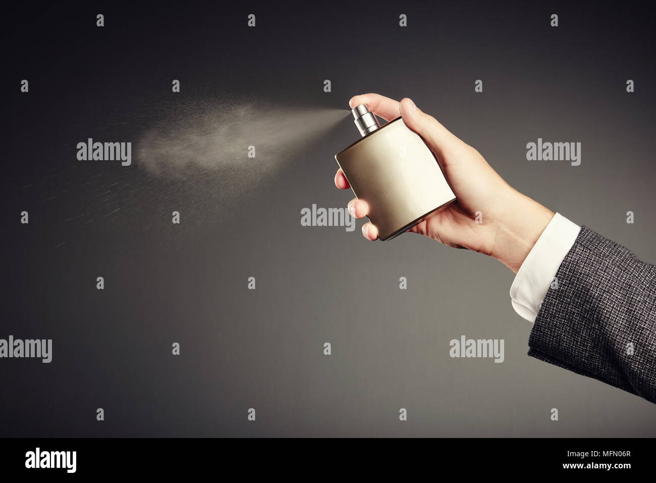 Man applying Perfume. Man's Perfume in the Hand on Black Background ...