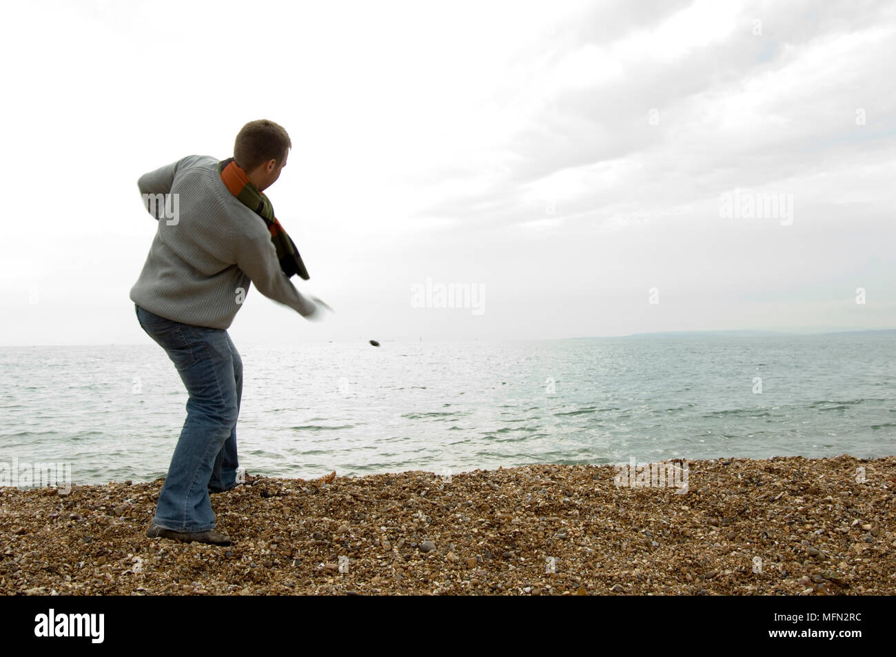 Throwing a stone into the sea hi-res stock photography and images - Alamy