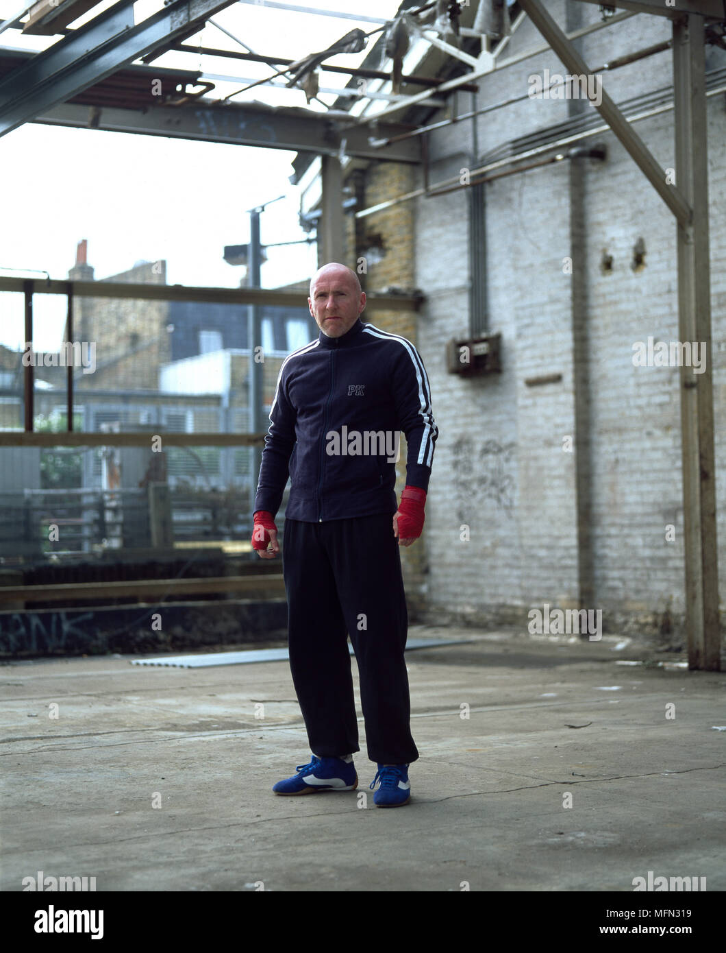 Senior boxer stood in a derelict warehouse Ref: CRB342 10021 034 ...