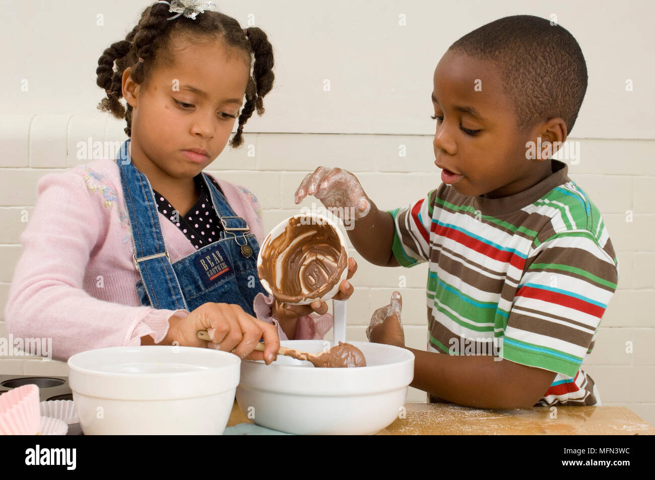 Close-up of a boy and a girl making a cake Ref: Compulsory Credit Stock ...