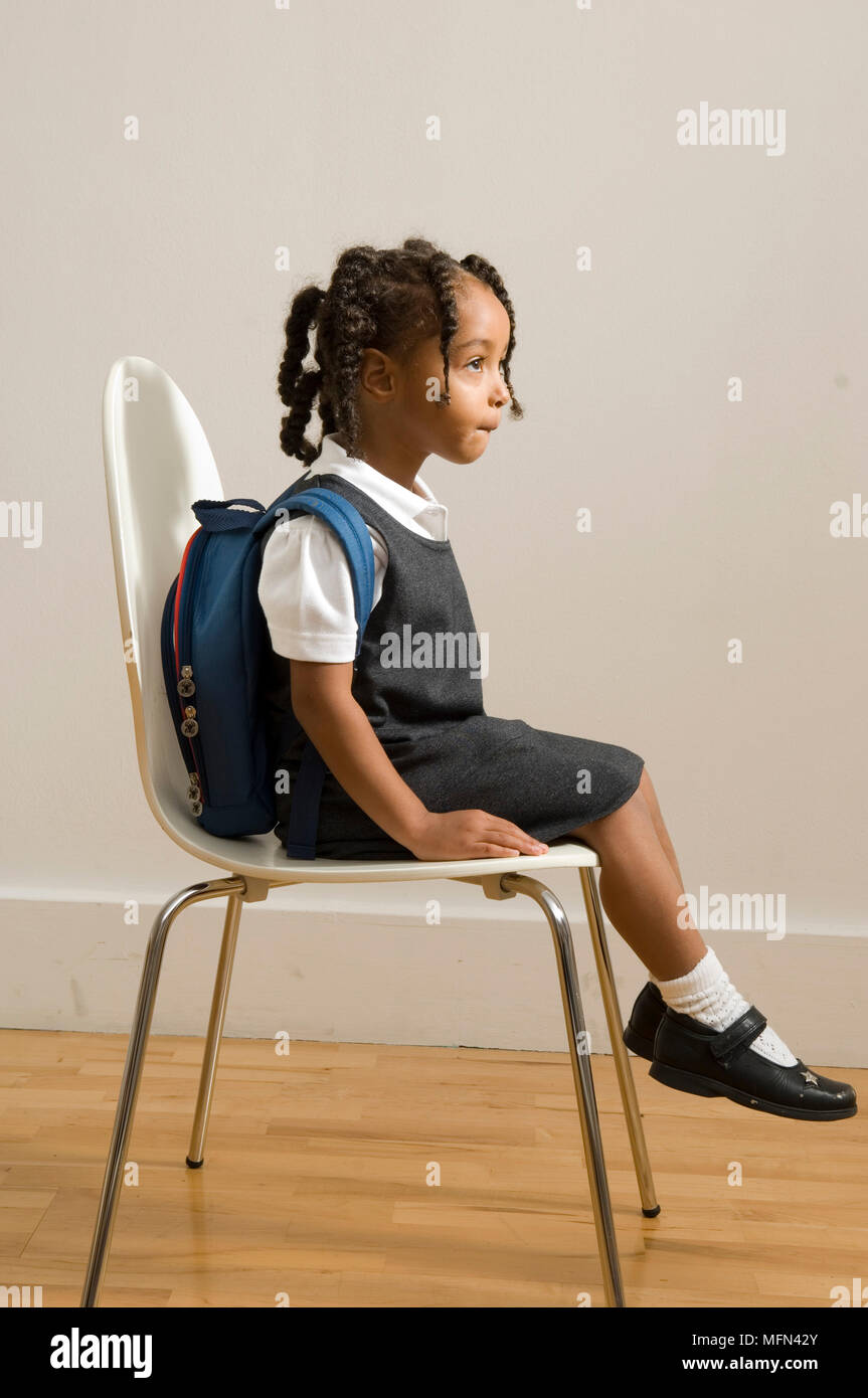 Side profile of a girl sitting on a chair and making a face Ref ...