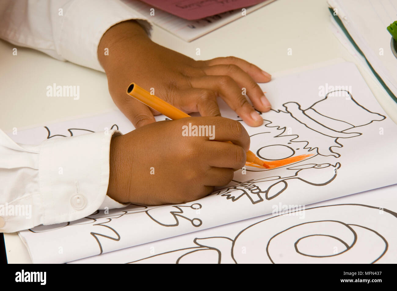 High angle view of a human hand drawing on a book Ref: Compulsory ...