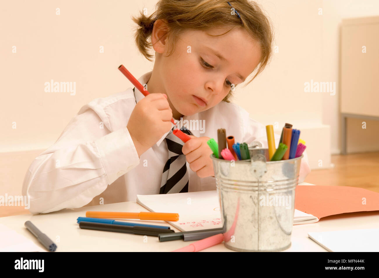Child drawing in notebook looking hi-res stock photography and images ...