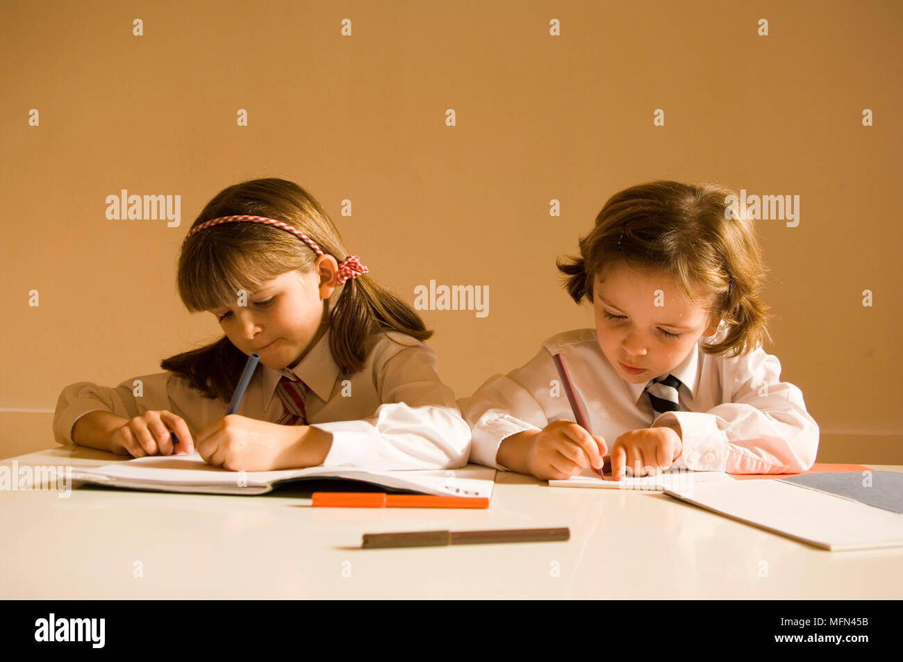 Two girls writing on spiral notebooks Ref: Compulsory Credit Stock ...