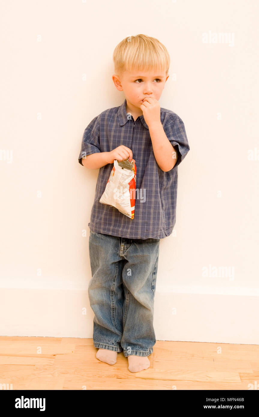 Child eating crisps packet hi-res stock photography and images - Alamy