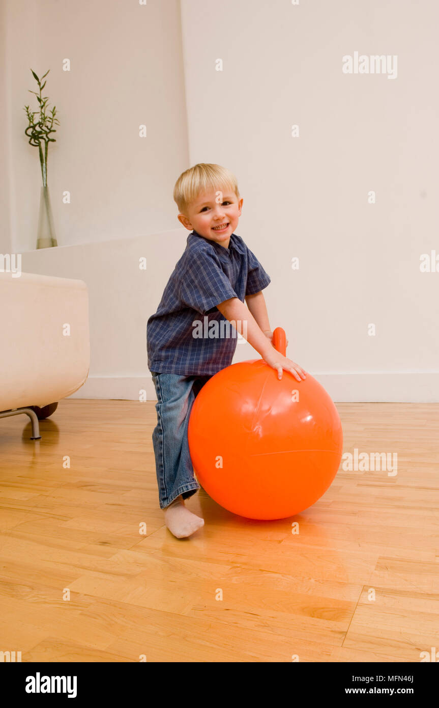 Portrait of a boy playing with a space hopper Ref: Compulsory Credit ...