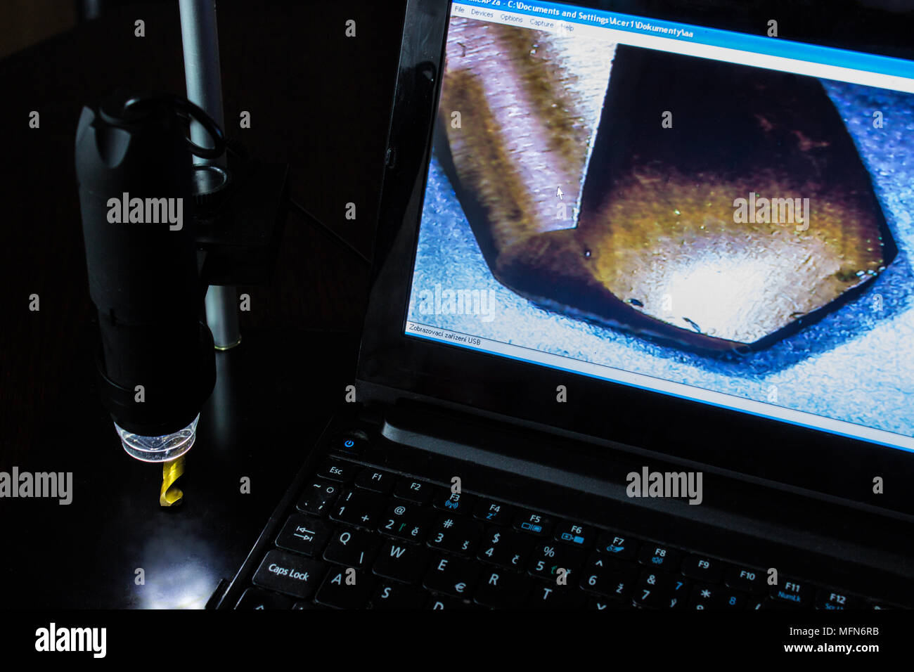 On the left is the drill under the microscope which is illuminated by ...