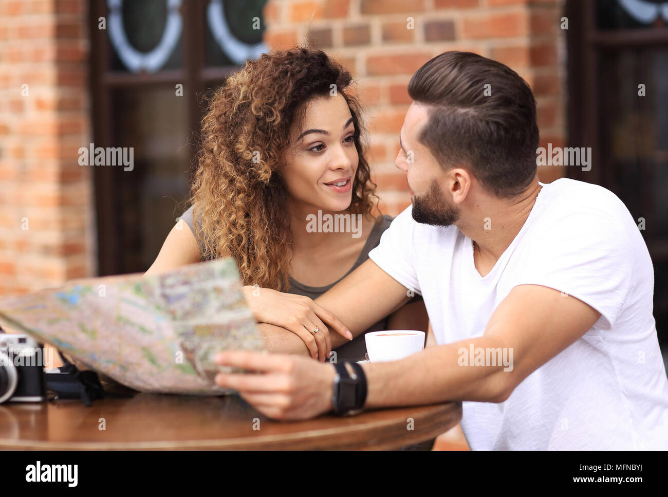 A picture of tourists looking at map in a cafe Stock Photo - Alamy