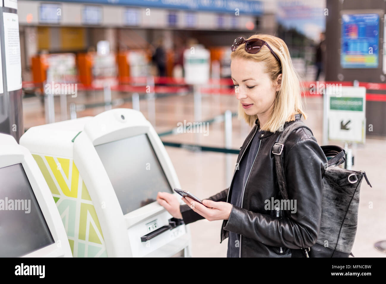 Casual caucasian woman using smart phone application and check-in ...