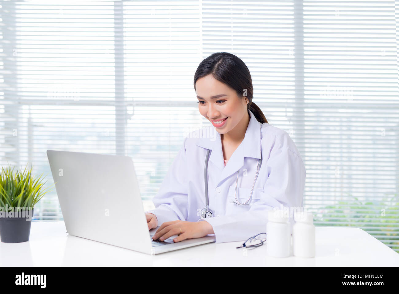 Doctor sitting at desk hi-res stock photography and images - Alamy