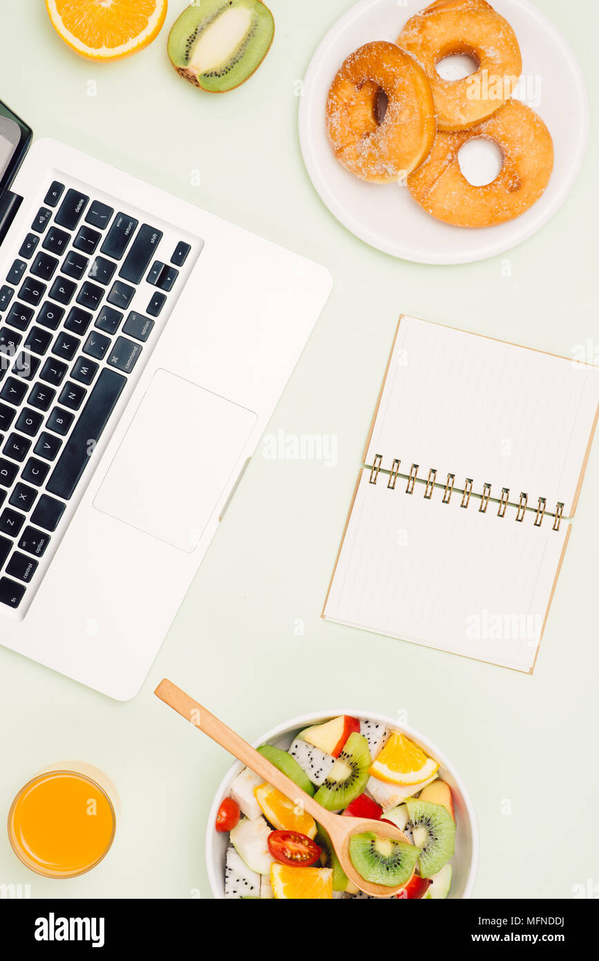 Healthy business lunch in office, fruit salad bowl near laptop on white ...