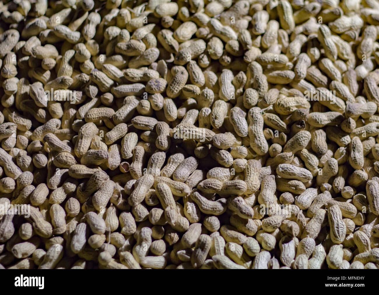 ground nuts in a heap for sale close up. peanut with shell Stock Photo ...