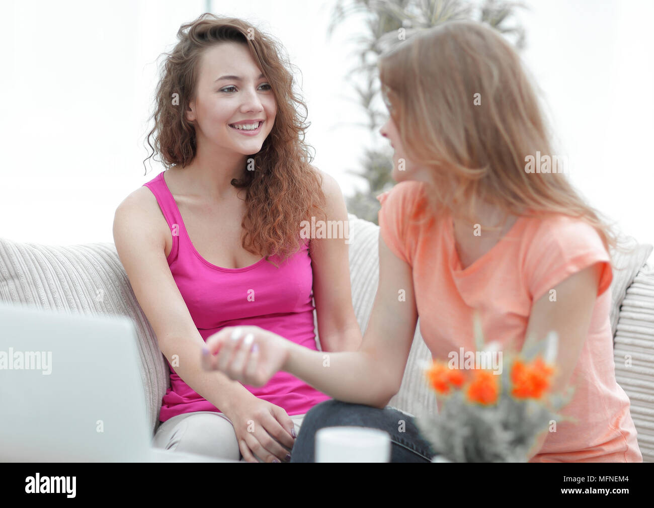 two young women talking and sitting down at the coffee table Stock ...