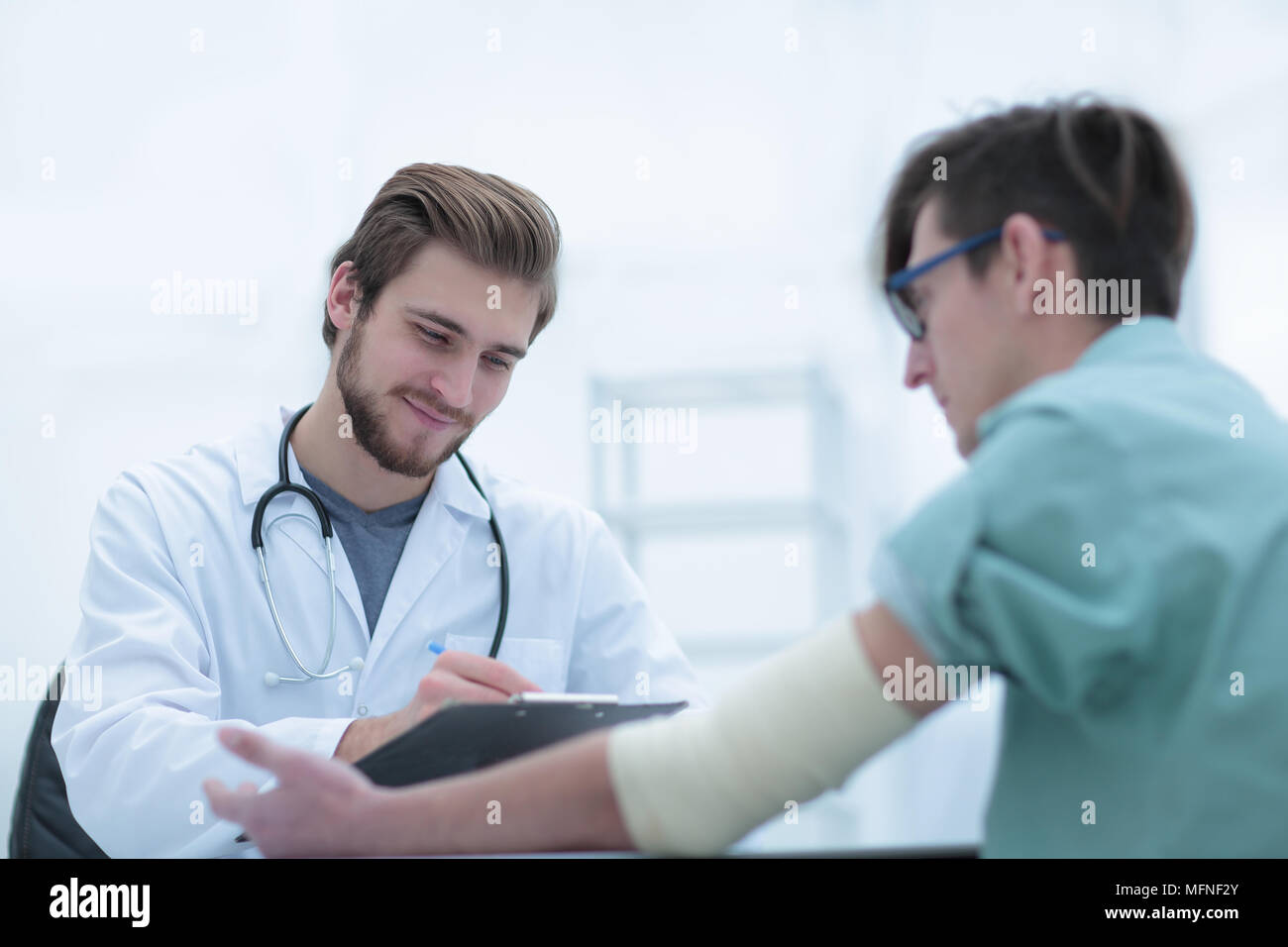 doctor writing a prescription to her patient Stock Photo - Alamy