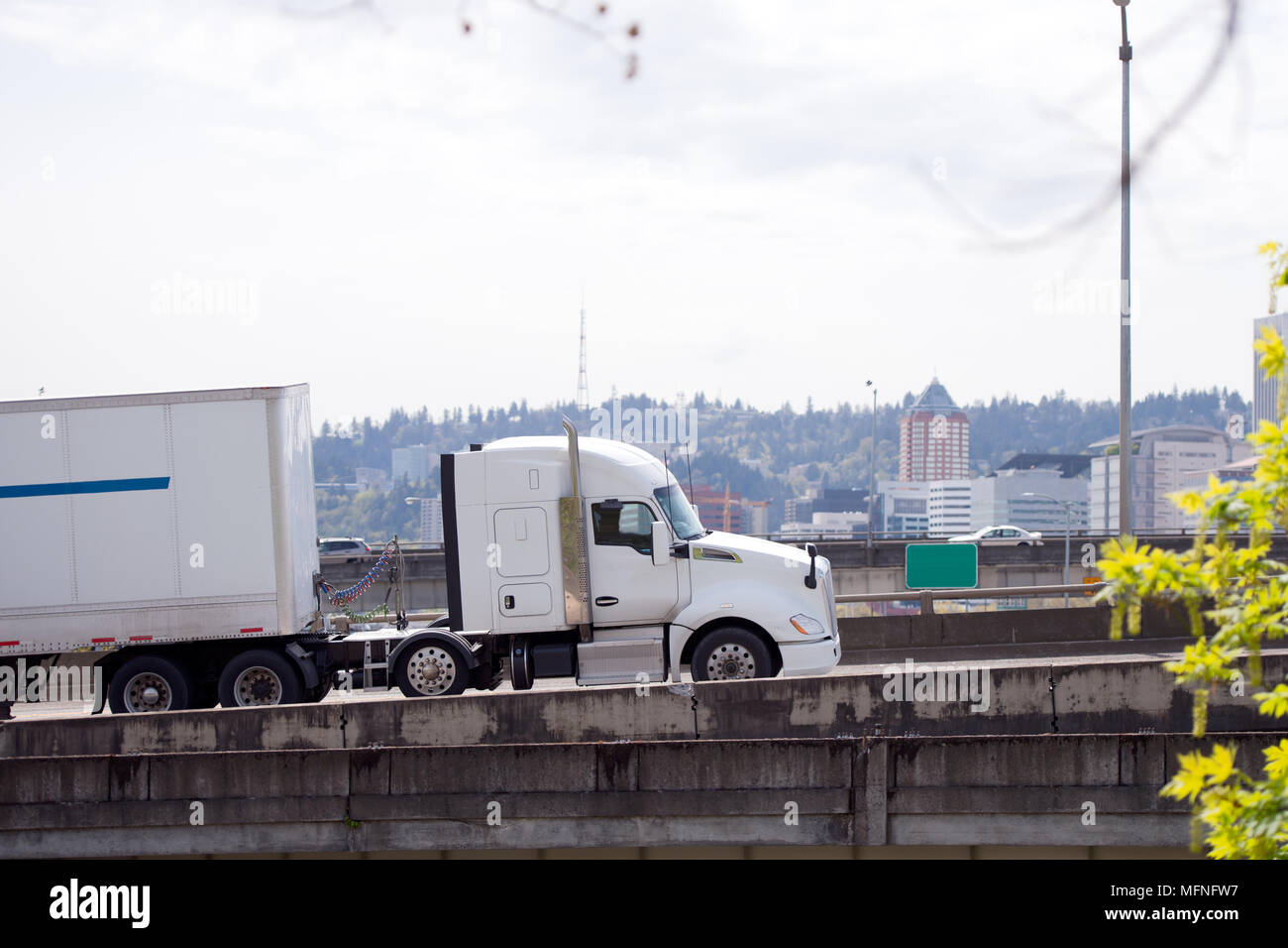 Profile of white powerful American bonnet professional big rig semi ...