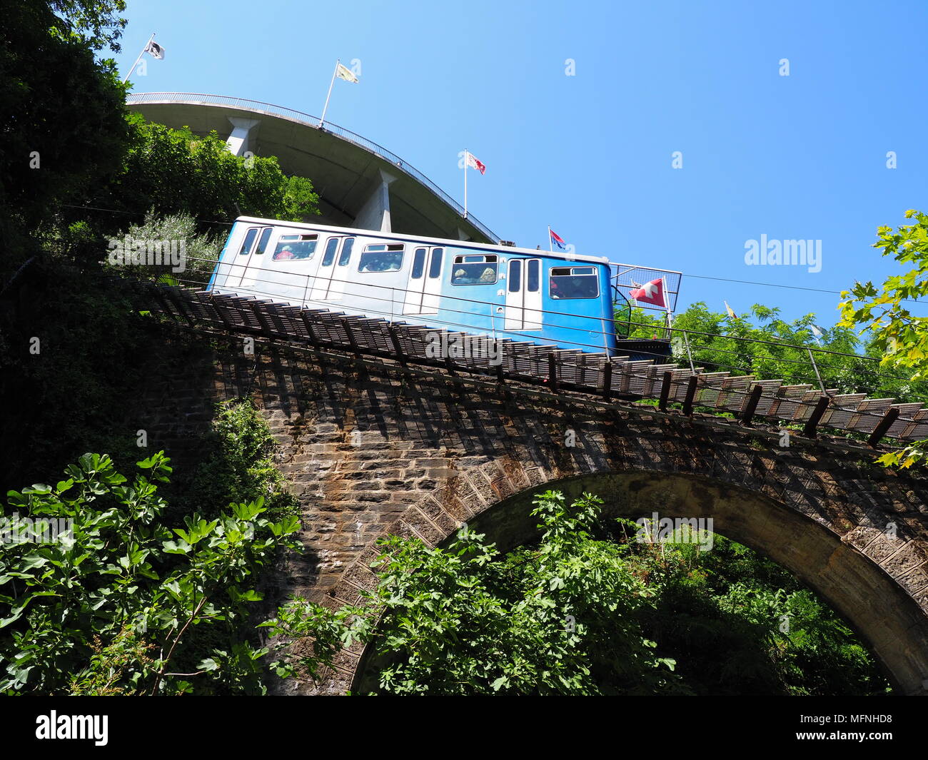 Tourist train on funicular railway on stony bridge in european city of ...