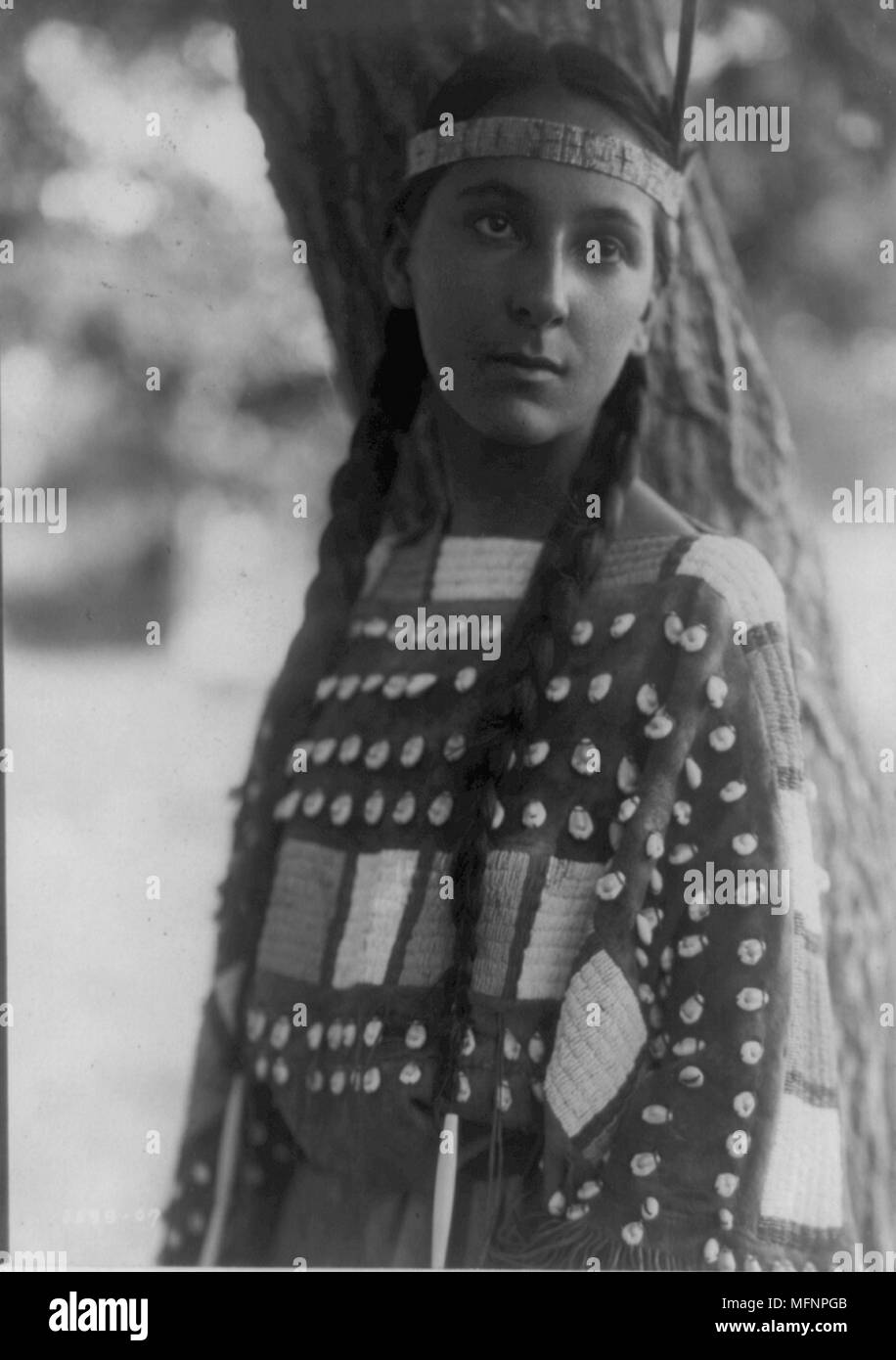 Young Native American woman, half-length, portrait, standing, facing ...