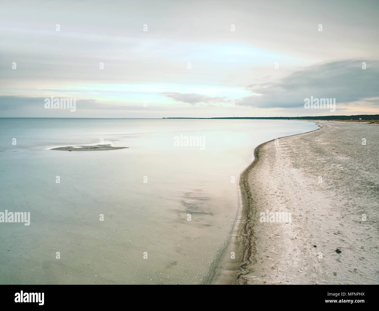 Beautiful misty sunrise on the German ocean coast. Heavy mist flowing ...