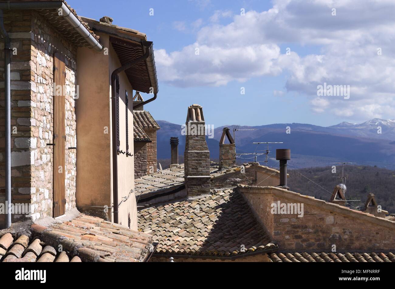 Italian landscape behind roofs and chimneys (Collepino, Umbria, Italy ...