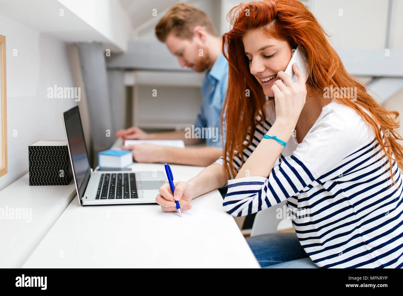 Woman calling partner from office Stock Photo - Alamy