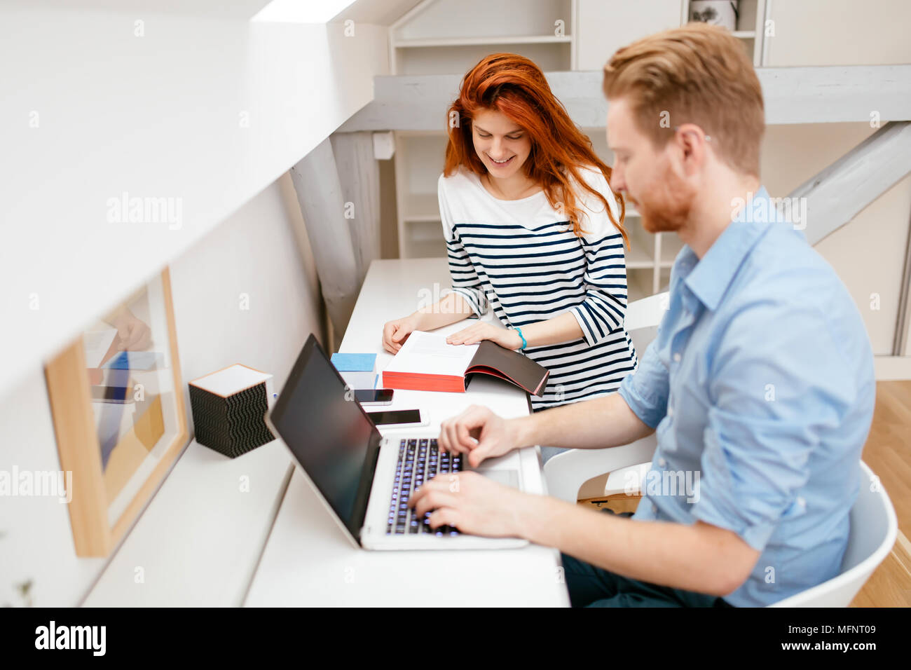 Colleagues working studying in white office Stock Photo - Alamy