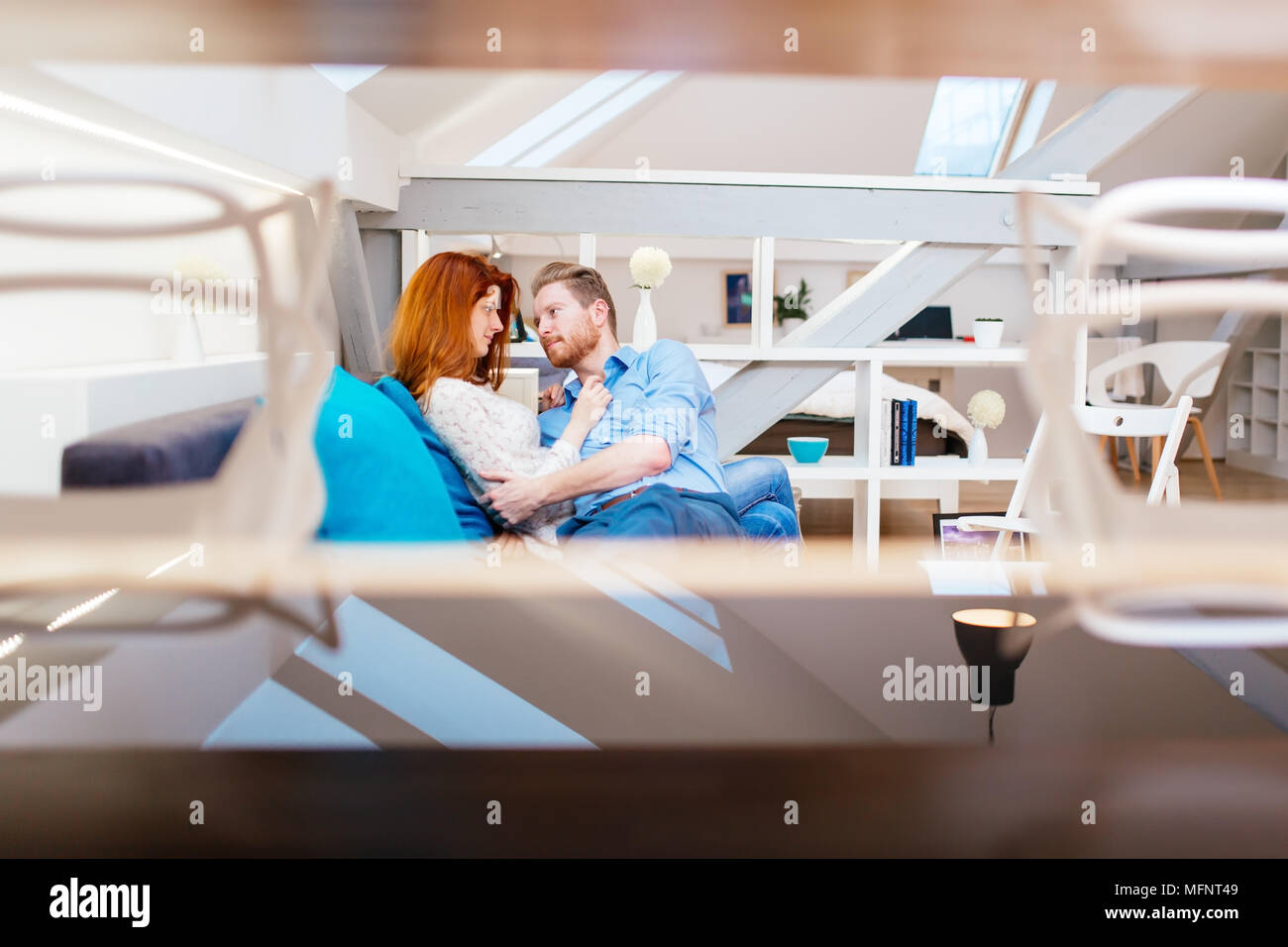 Couple cuddling sofa hi-res stock photography and images - Alamy