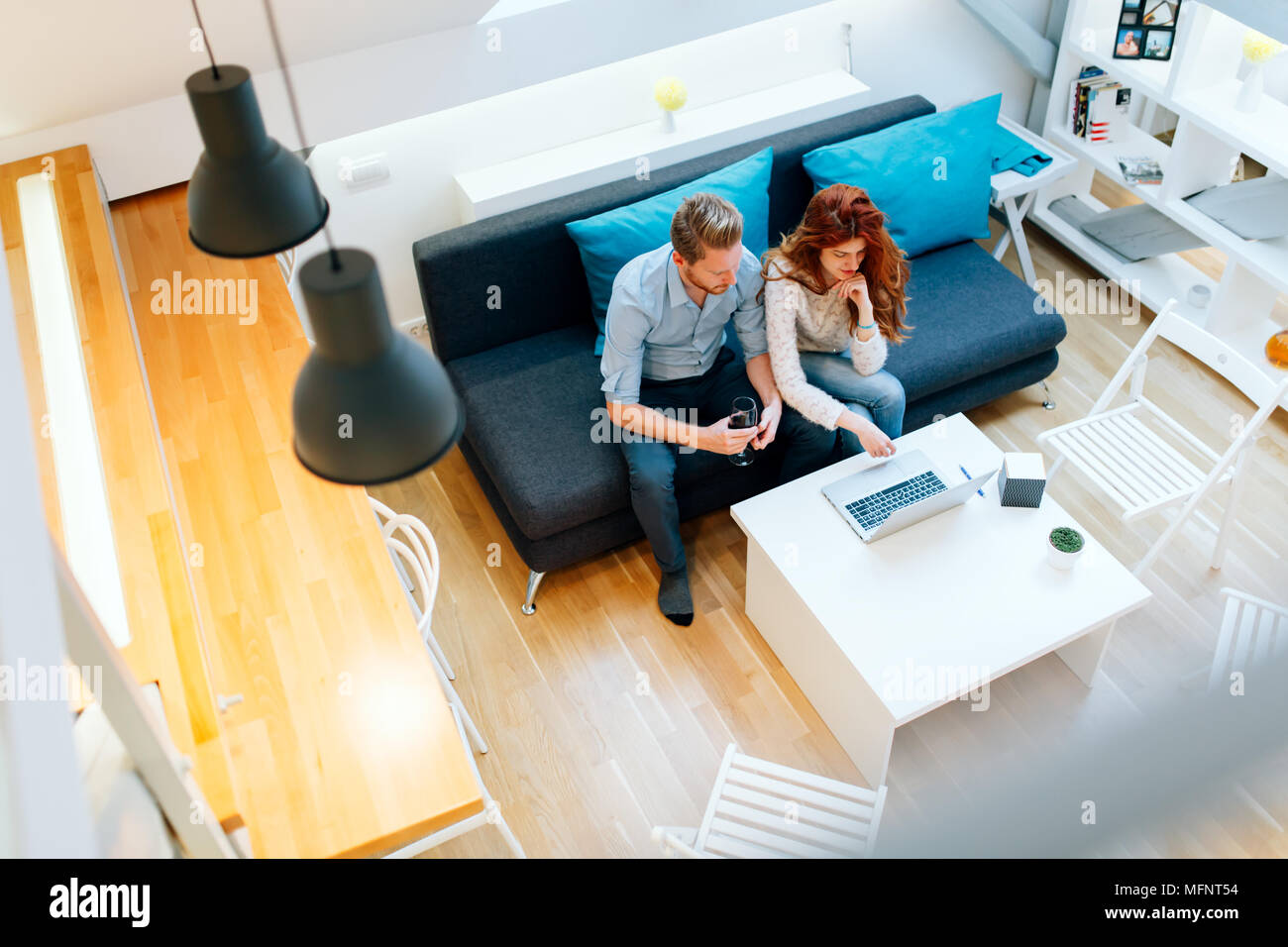Couple working together in beautiful living room Stock Photo - Alamy