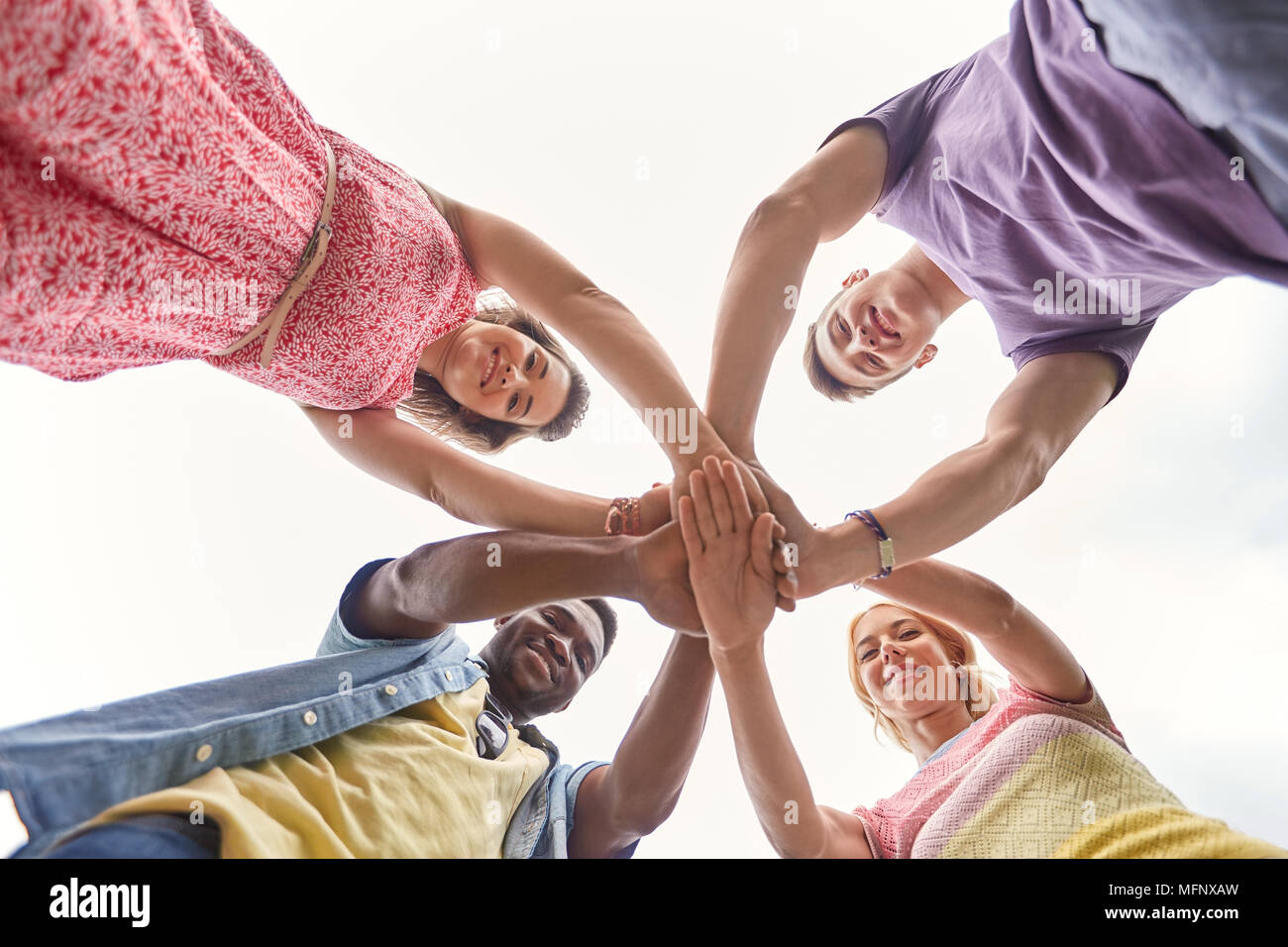 group of happy friends holding hands Stock Photo - Alamy