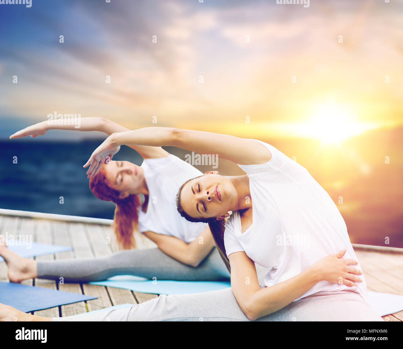 Woman doing exercises sunrise hi-res stock photography and images - Alamy