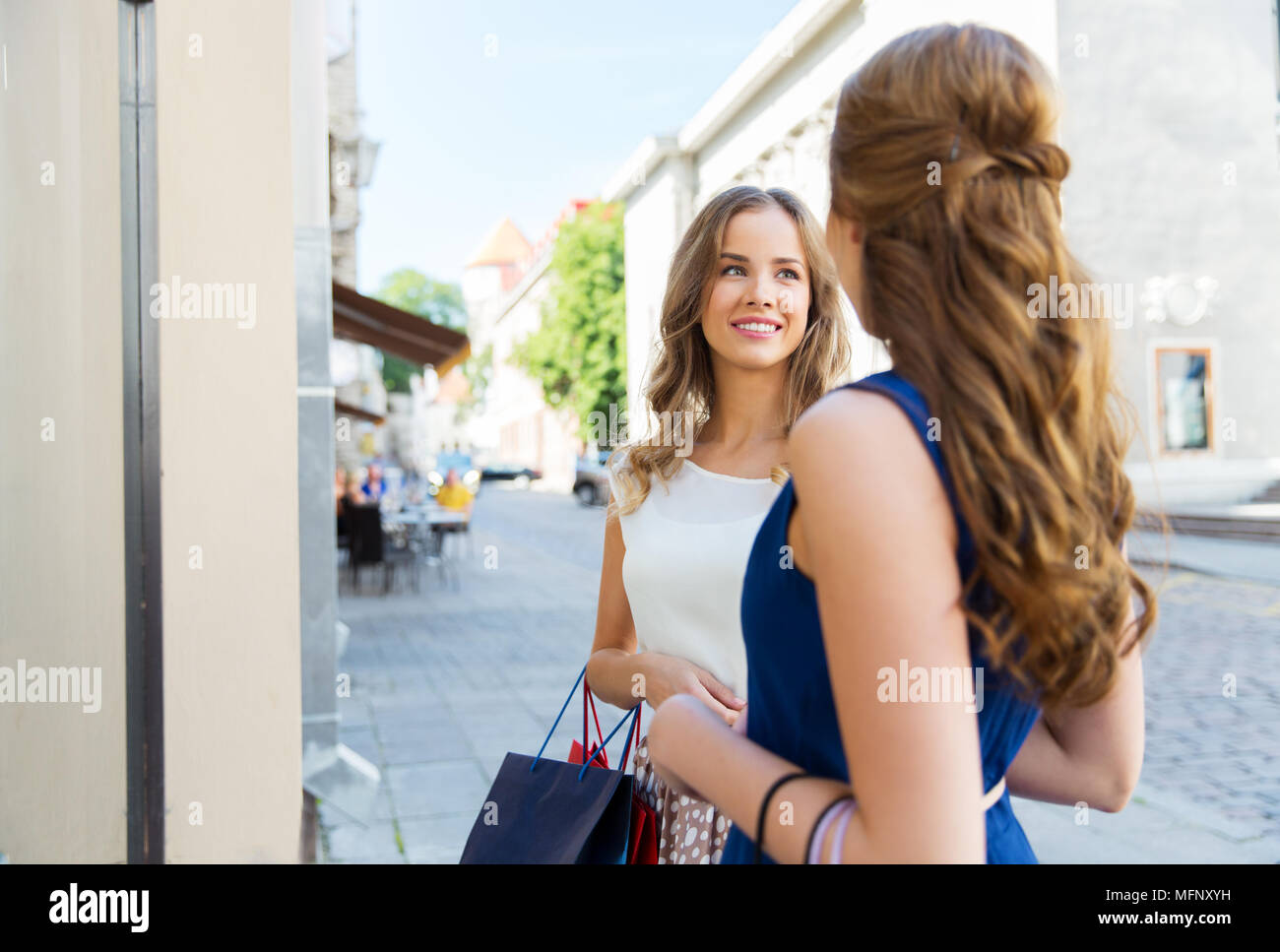 happy women with shopping bags at storefront Stock Photo - Alamy