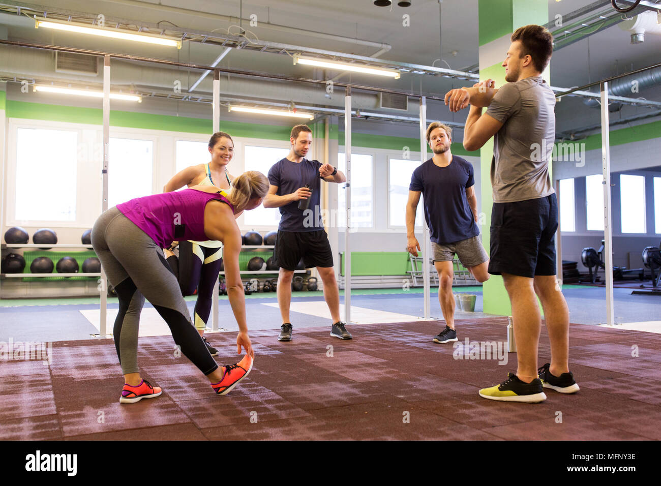 People Stretching At Gym