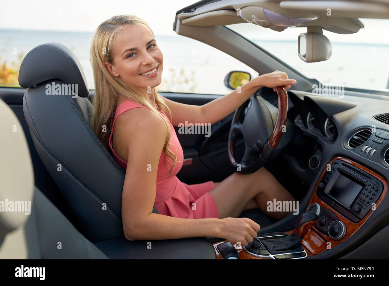 happy young woman driving convertible car Stock Photo - Alamy